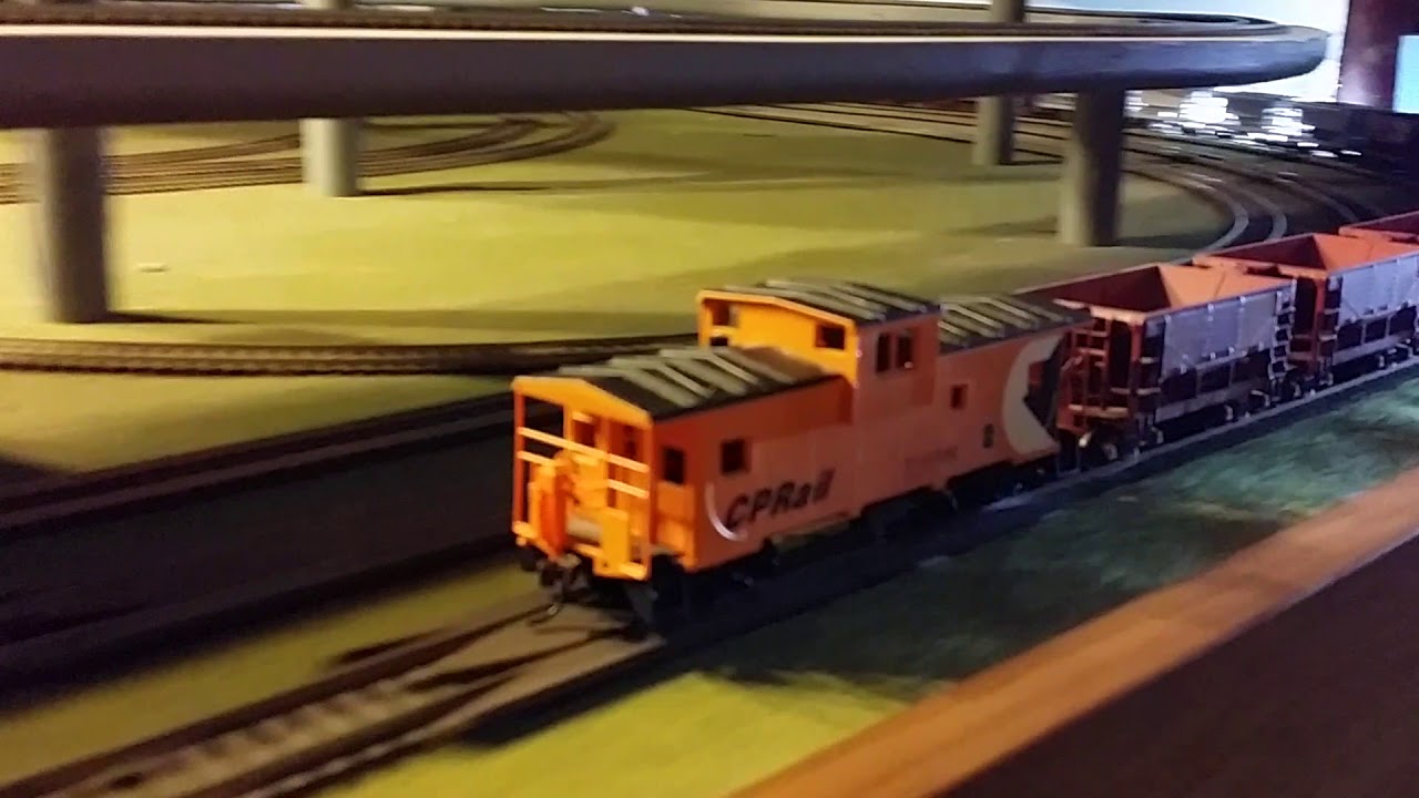 Model Train Locomotive With Several Iron Ore Cars And Caboose - YouTube