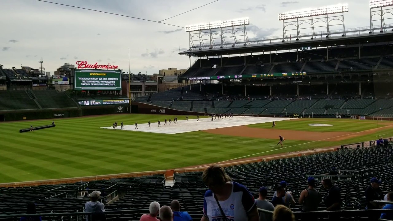 08-28-18 Cubs v. Mets game, rolling up the rain tarp at Wrigley Field ...