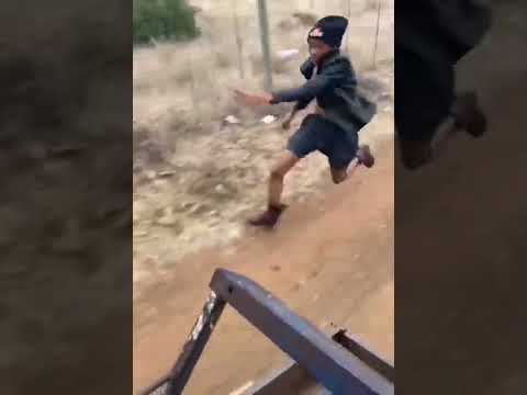 Two boys riding donkeys