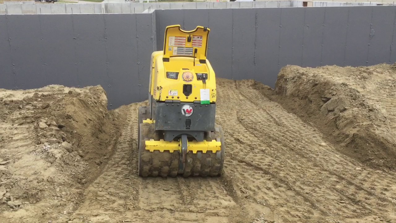 Wacker walk behind trench roller doing its thing - YouTube