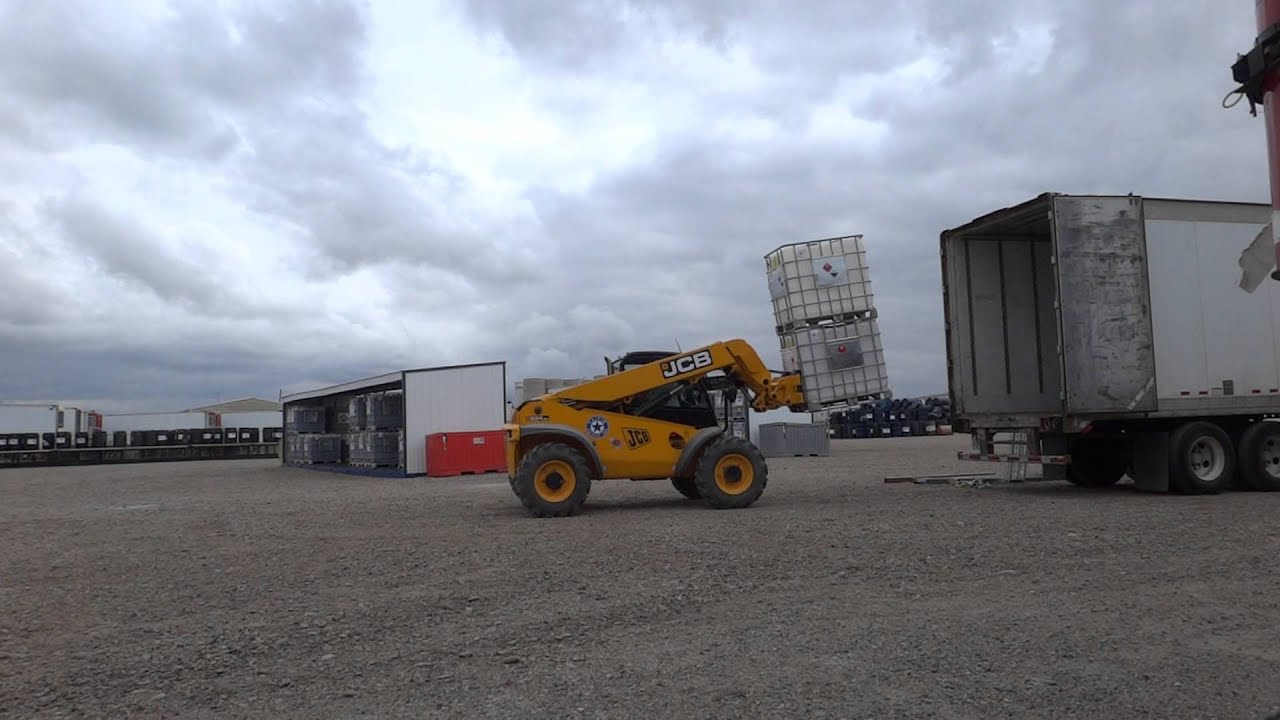 Telehandler loading liquid waste into semi trailer - YouTube