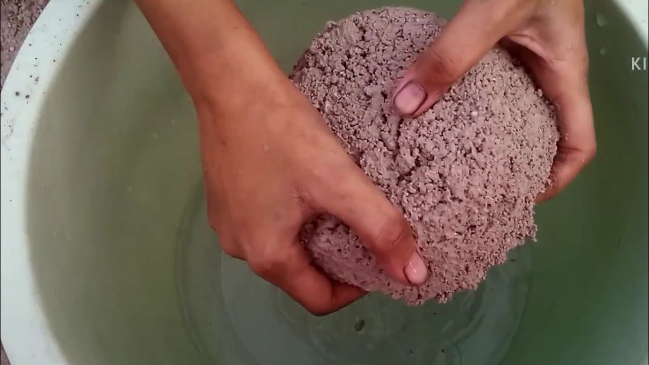 Full crunchy gritty dusty sand cement bowles crumbling in water bucket ...