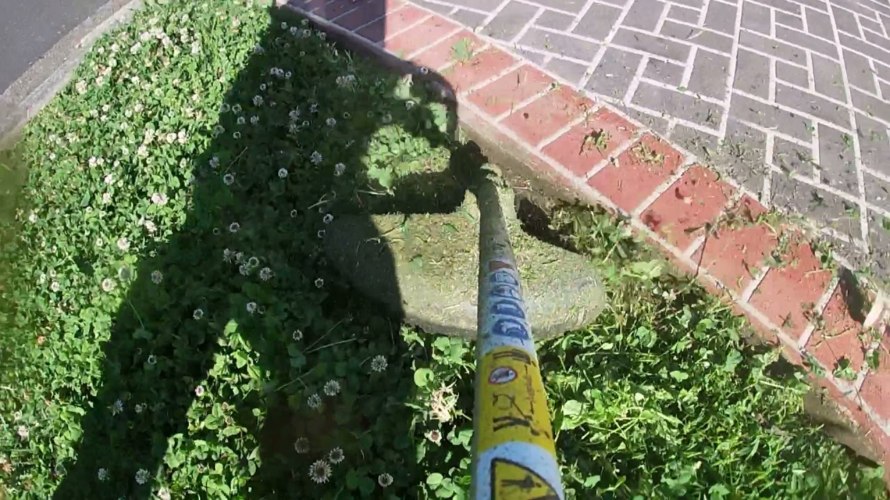 Whipper snipping the edges at the mowing job - YouTube