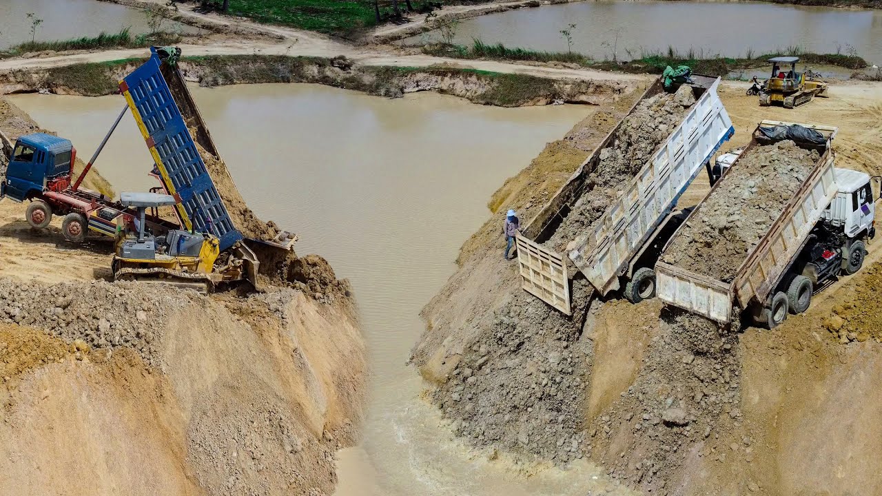 Best Filling up land processing Dump truck unloading soil with DozerD31 ...