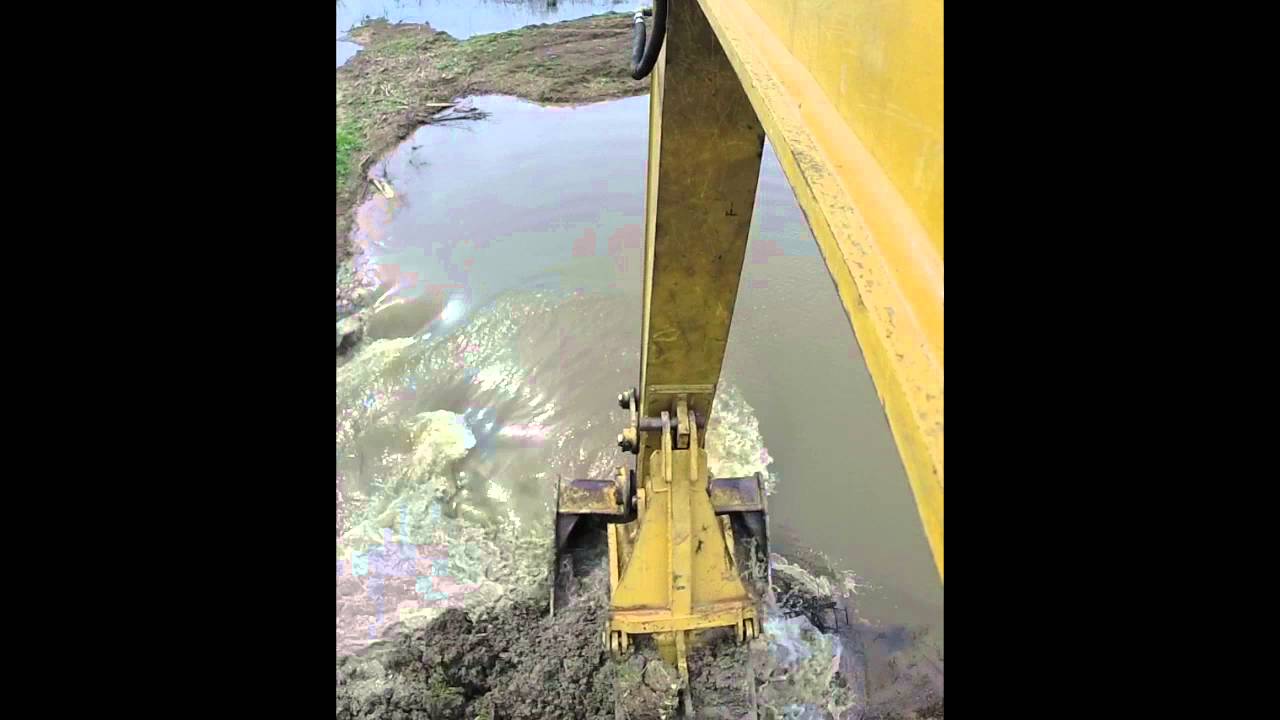 Trackhoe Breaking The Levee on the Duck Pond, Flooded Field Caterpillar ...