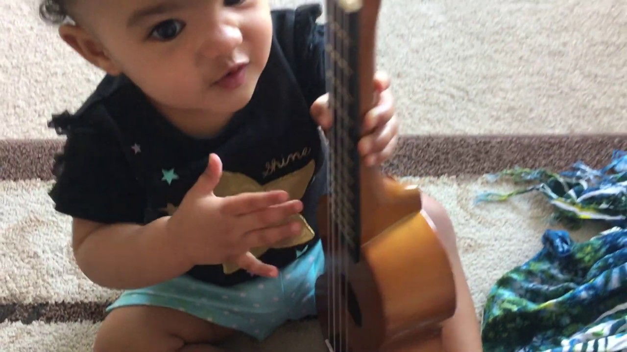 Baby tuning, playing and singing to ukulele. * Baby loves musical ...