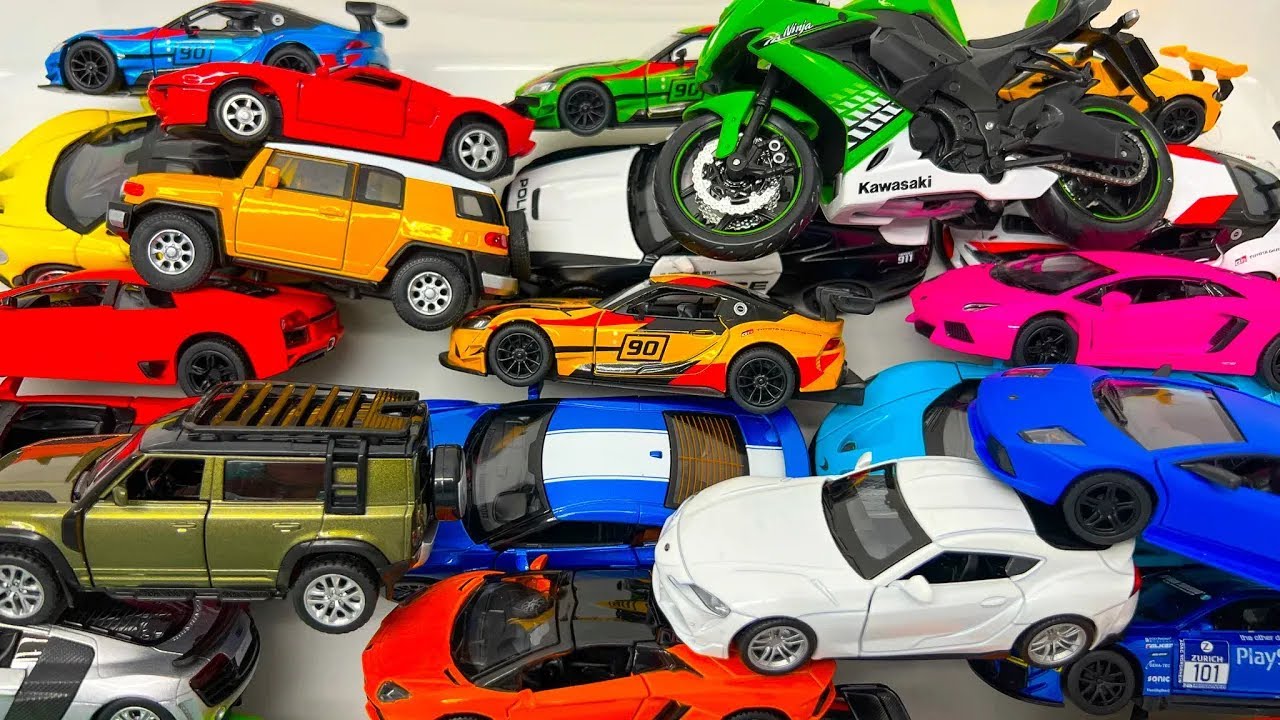 A Box Full Of Metal Cars Big And Small Land Rover, Porsche, Ferrari ...