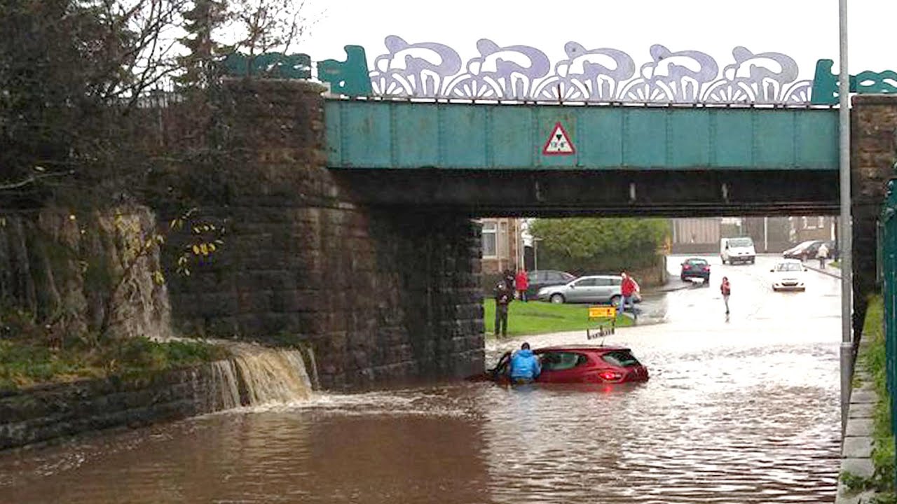 Homes and roads flood after heavy rain in Lancashire and north Wales ...