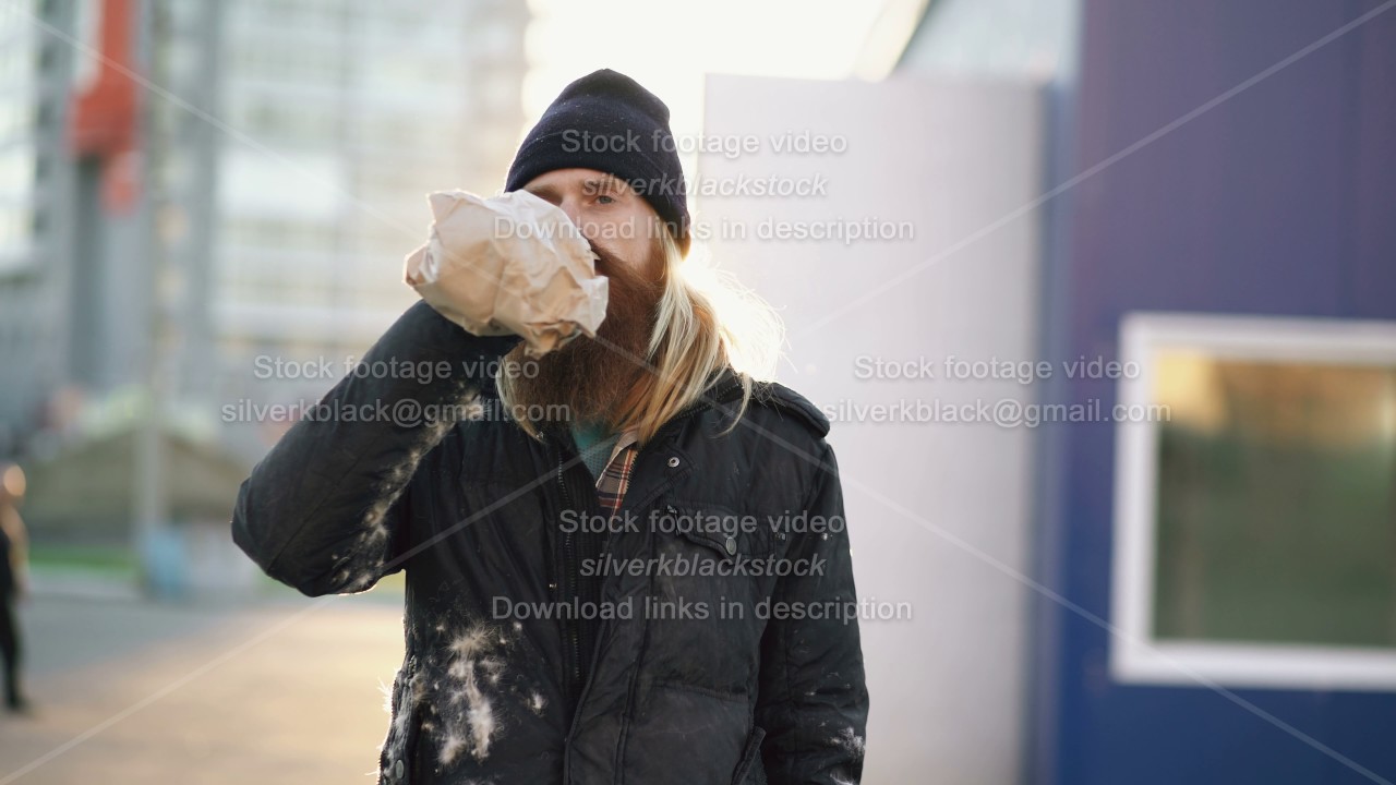 Portrait of Drunk homeless man with drink alcohol from paper bag while ...
