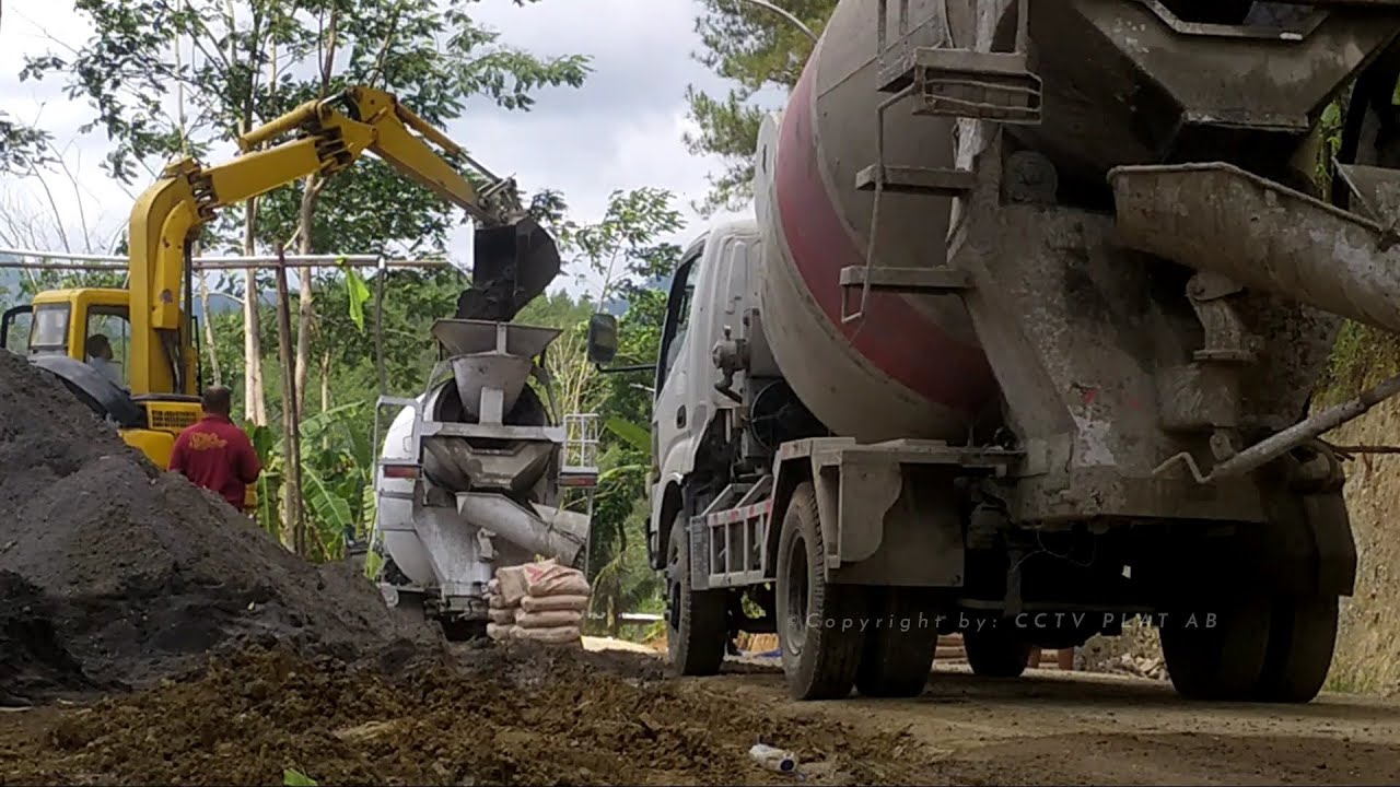 Excavator Works to Loading Material Into Ready Mix Truck - YouTube
