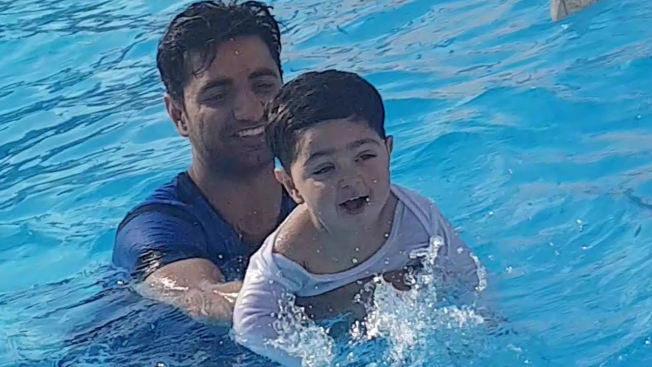 Baby swimming /baby having fun in the pool /one year old baby trying to ...