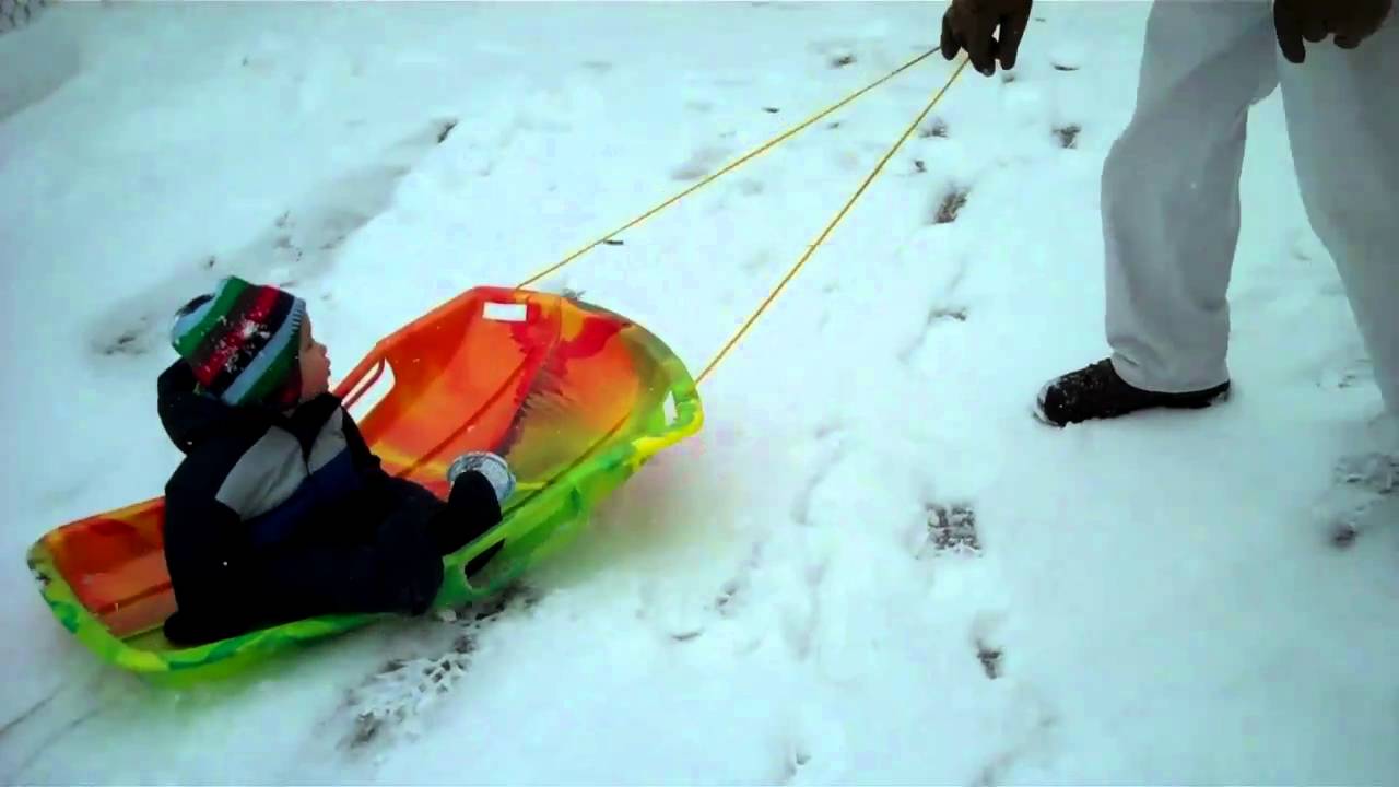 Baby's first sled ride in the snow - YouTube