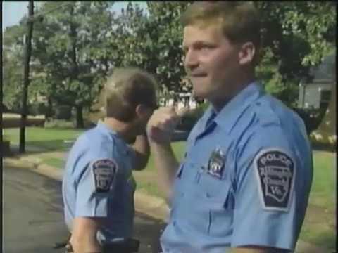 Cop asks AIDS activists to take a huge condom off of Sen. Jesse Helms's ...