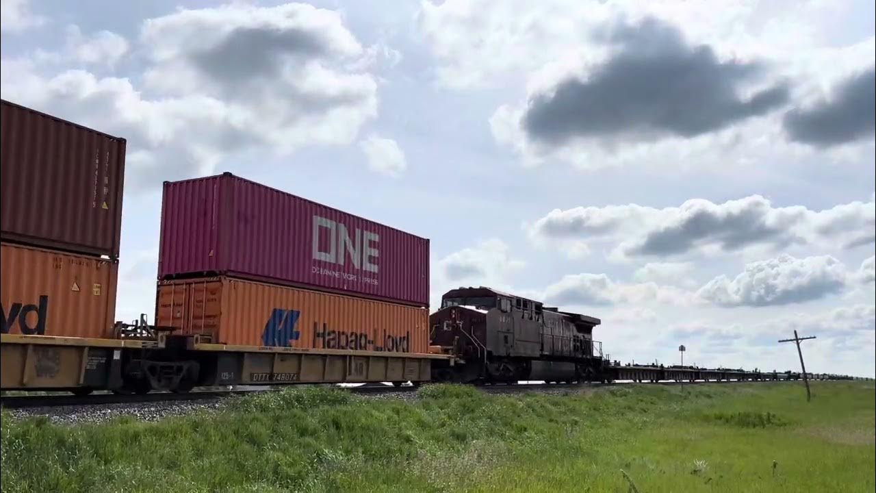 CPKC westbound auto rack/intermodal highballing into Bassano, AB on the Brooks sub - YouTube