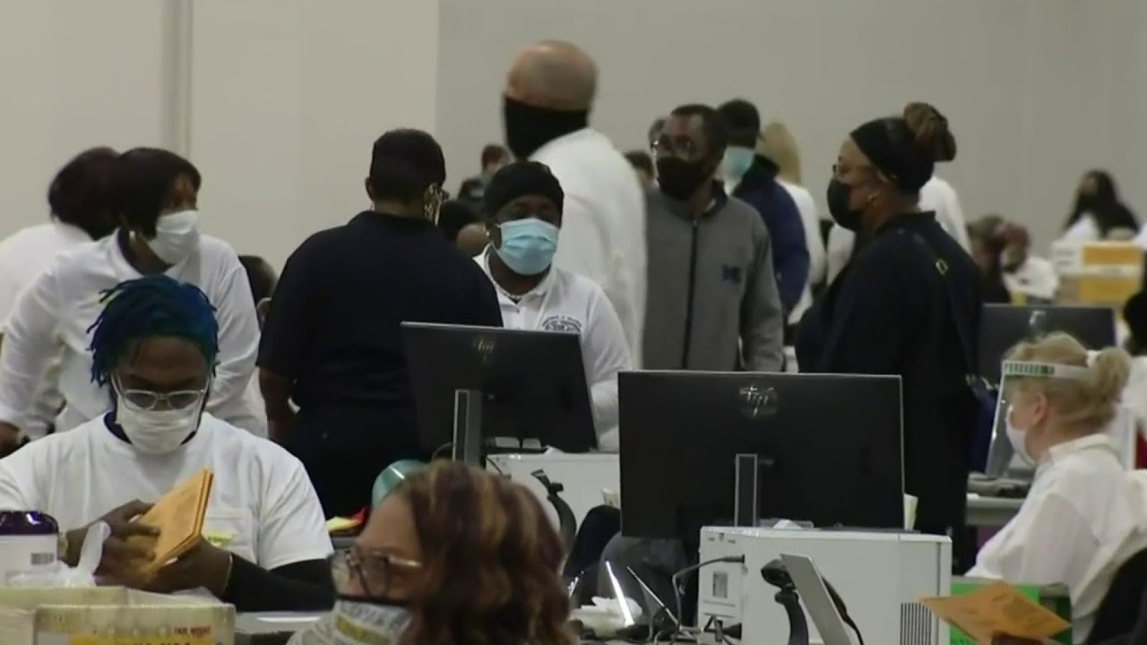 Election workers in Detroit counting absentee ballots at TCF Center ...