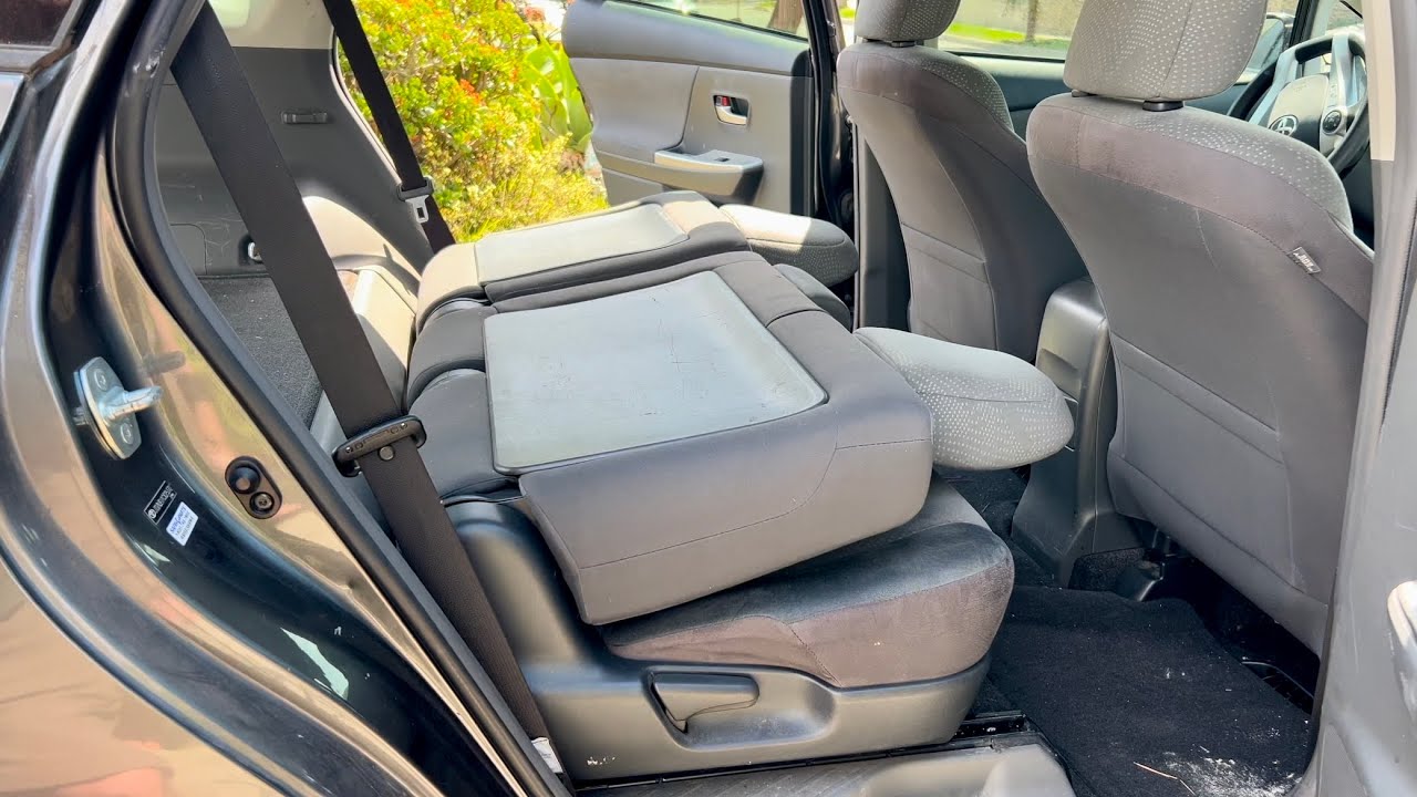 How to fold down the seats on a Toyota Prius V - YouTube