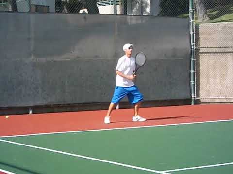 Brian Battistone hitting 2 forehands with the two-handled tennis racket ...