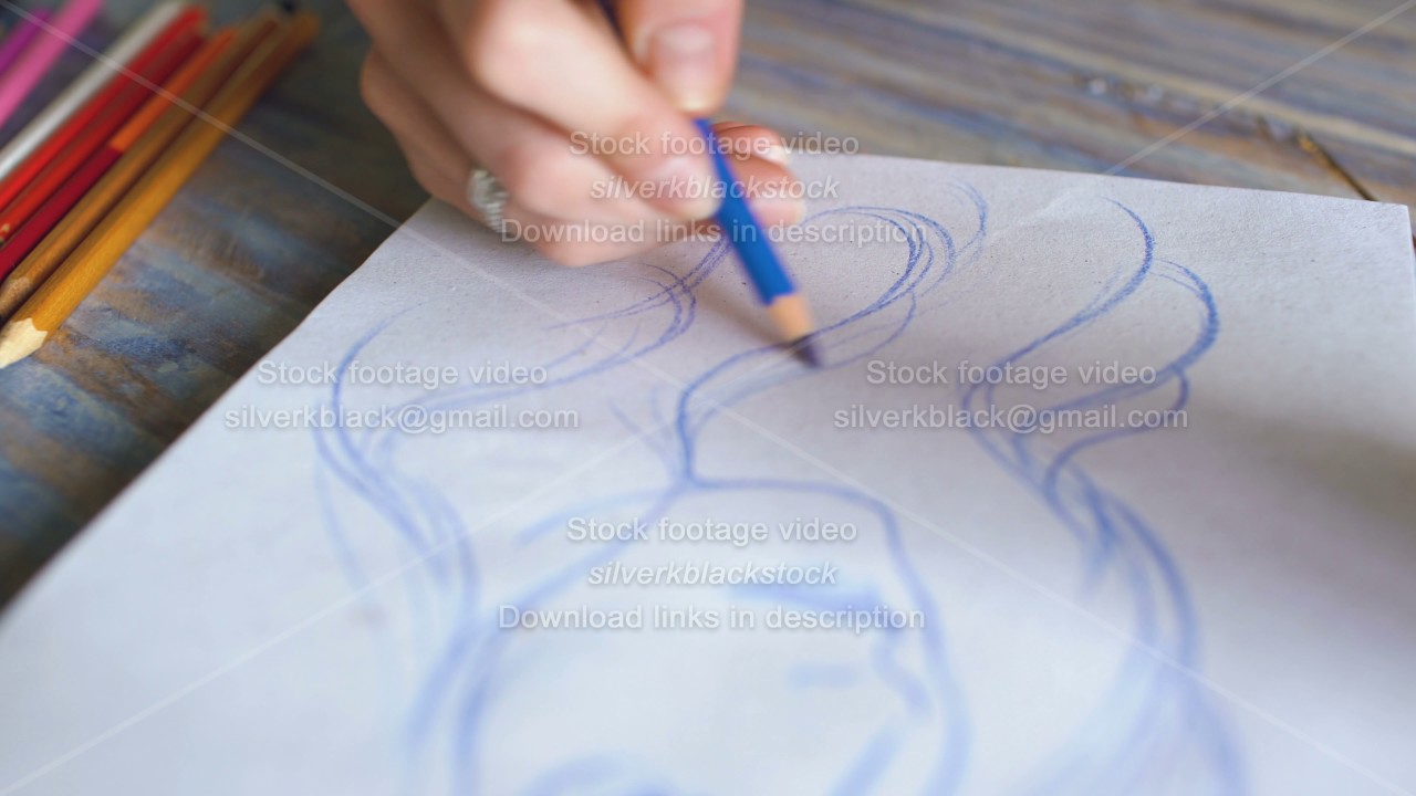 Young woman artist painting scetch on paper notebook with pencil ...