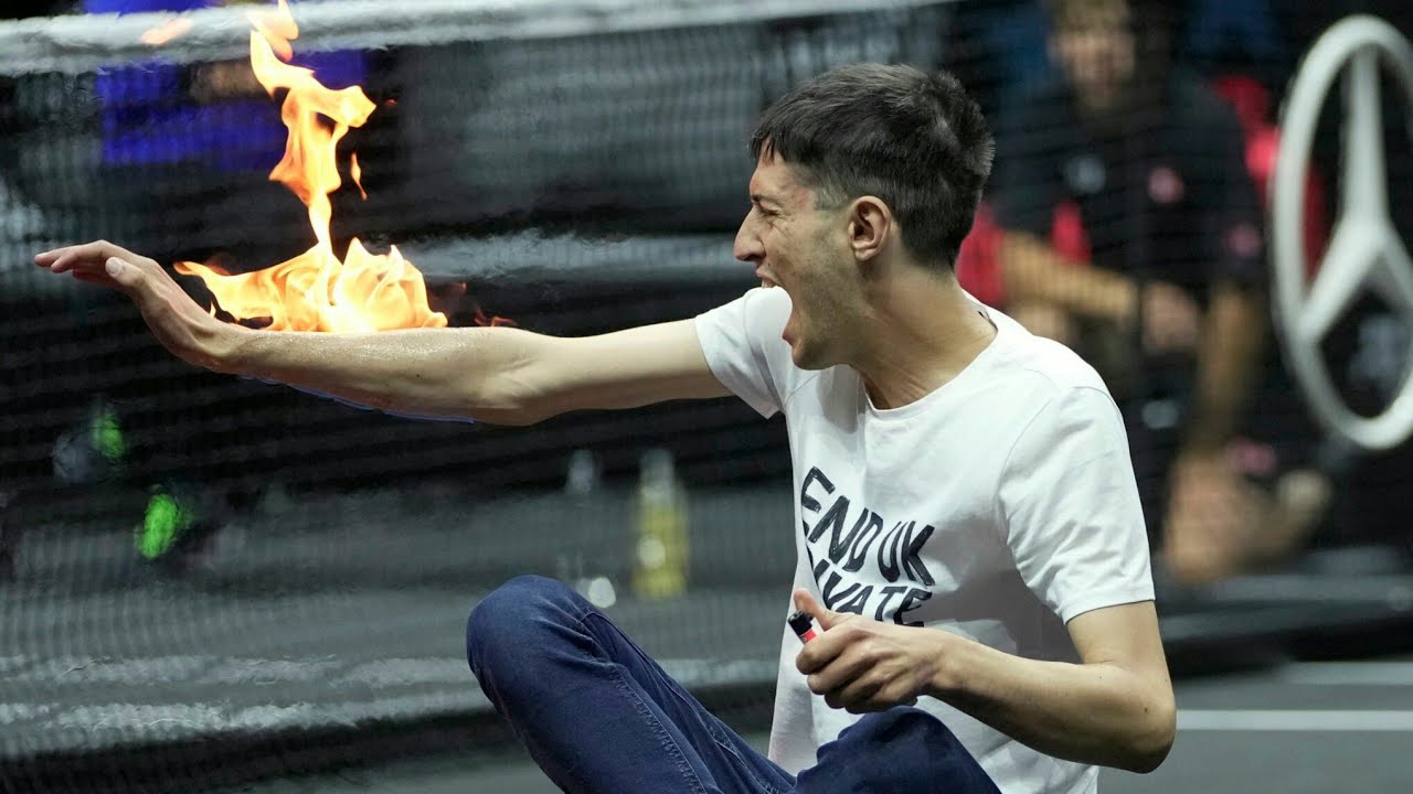 Protester sets his arm on fire during Laver Cup match in London - YouTube