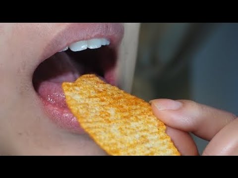 Girls eats crunchy oven baked chips. Camera Close Up. Chewed food ...