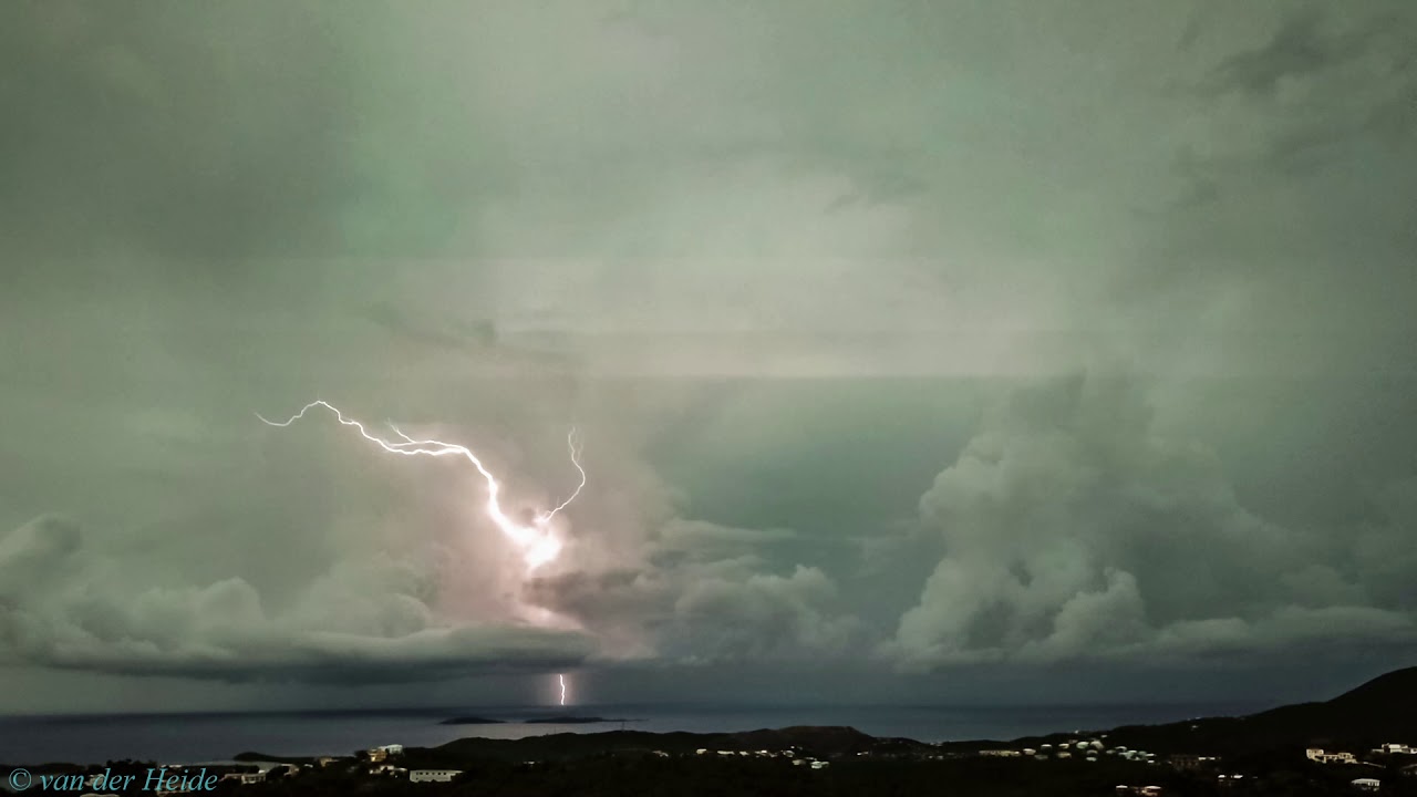 Lightning strikes the ocean behind island... - YouTube