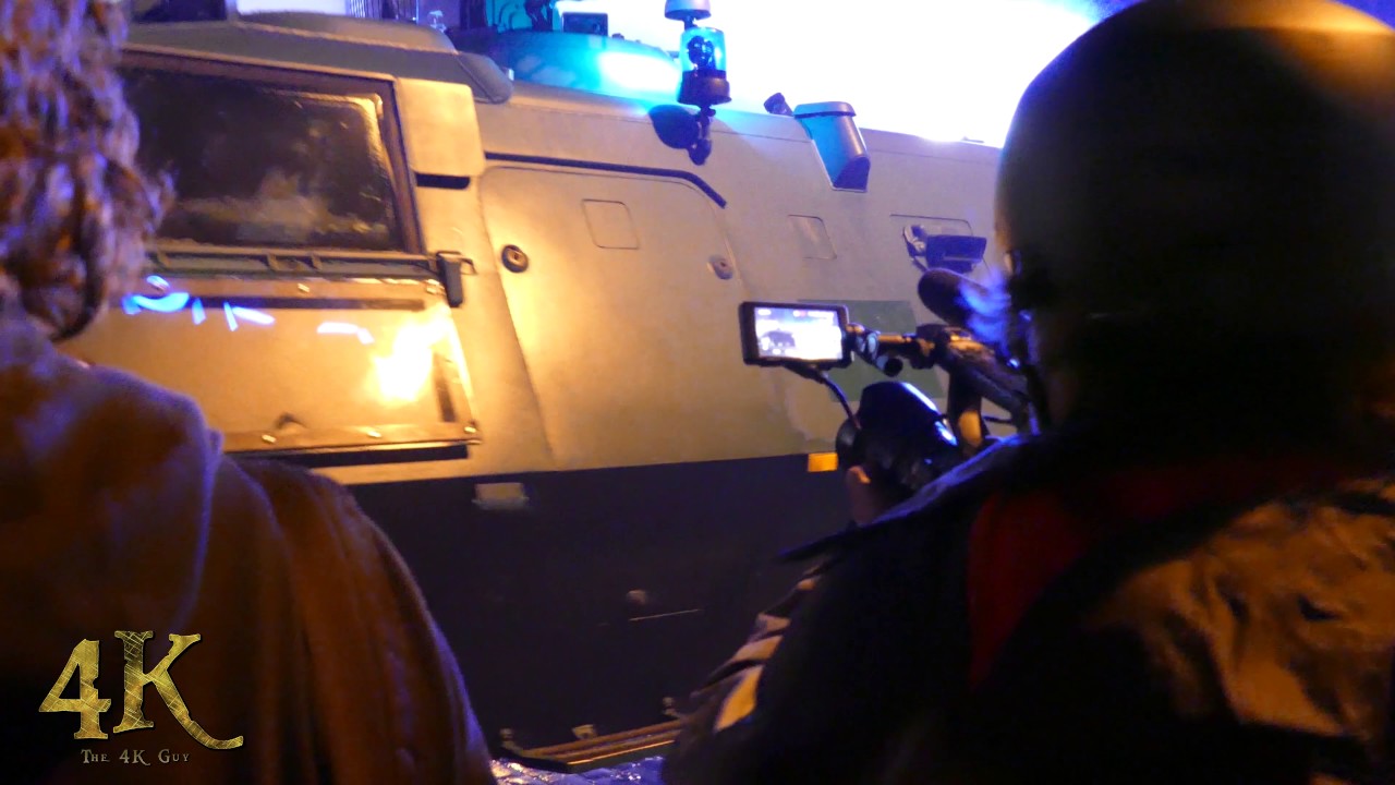 Armored Police Tank Driving Past Protesters In City - YouTube