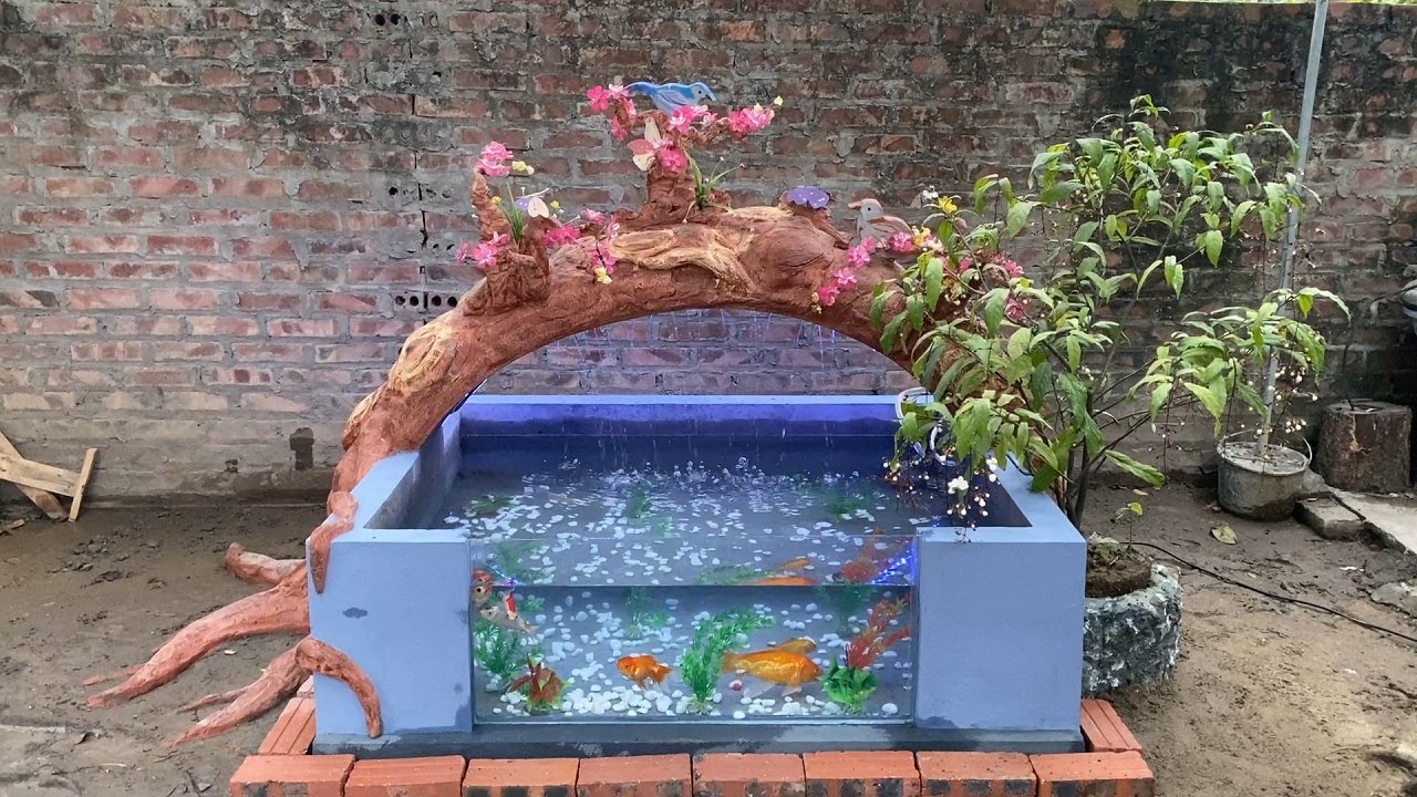 Aquarium and tree stump combination / Beautiful fish tank design from ...
