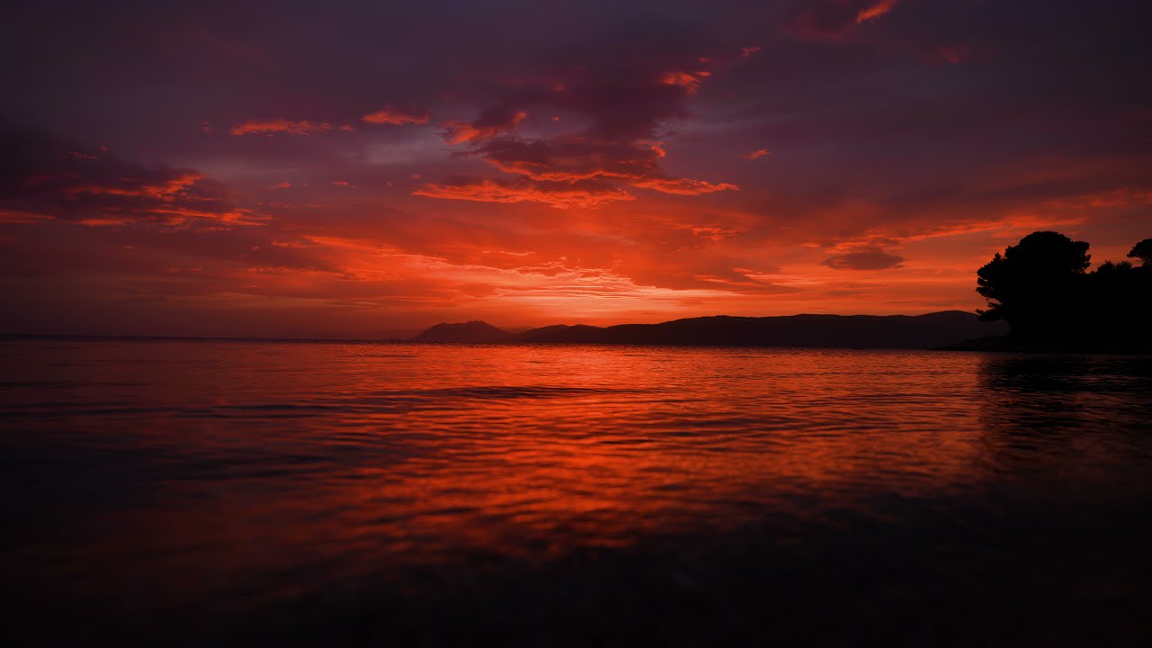 8K: Sunset afterglow with stunning colours and slow motion gentle waves ...