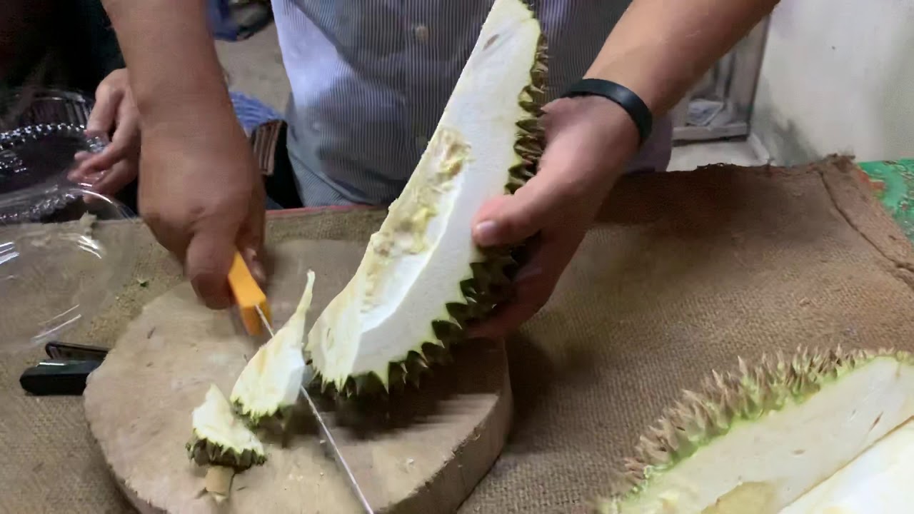 Cutting open a Durian in Thailand - YouTube