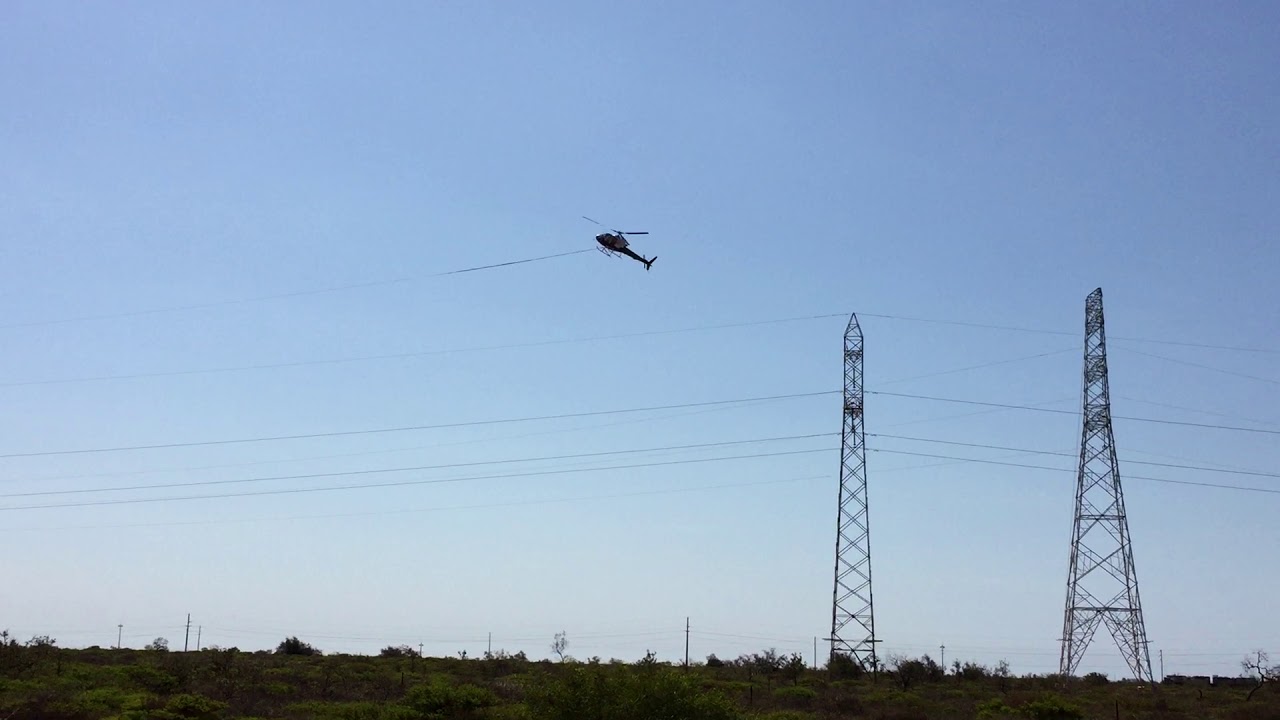 Using a helicopter to pull up a high voltage power line - YouTube