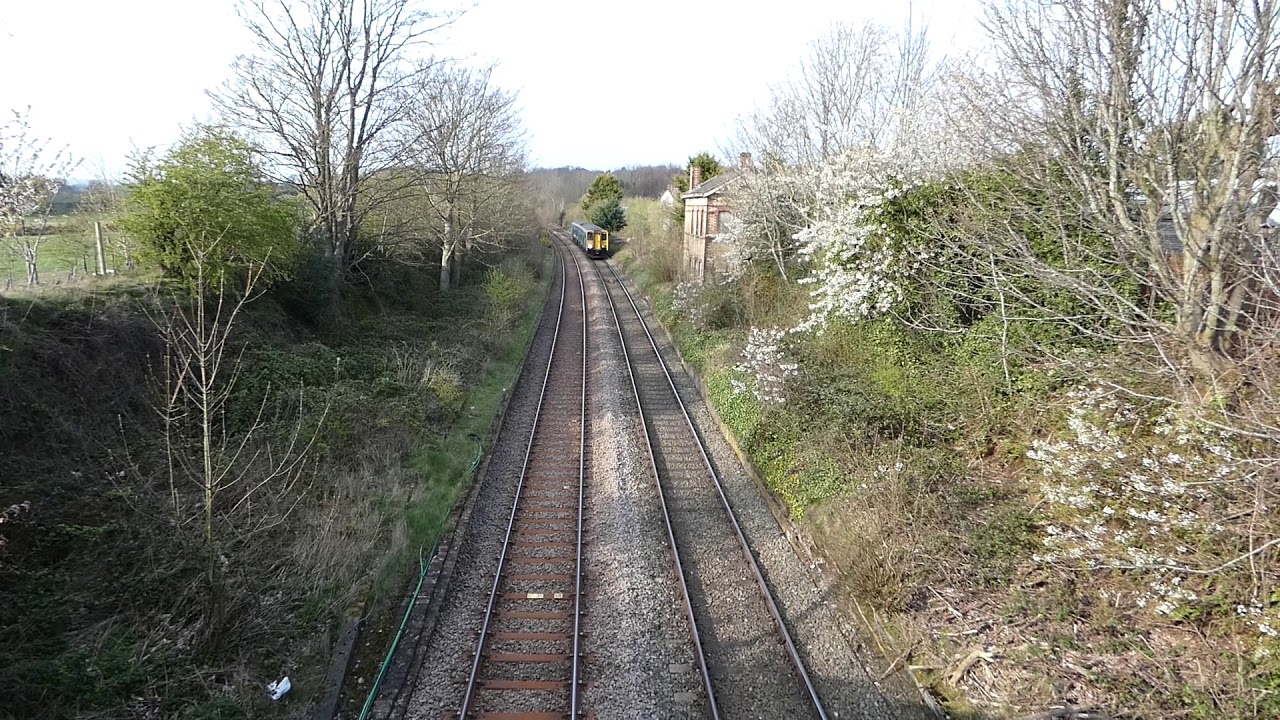 Neston to Shotton TFW train passes the old Burton Point railway station ...