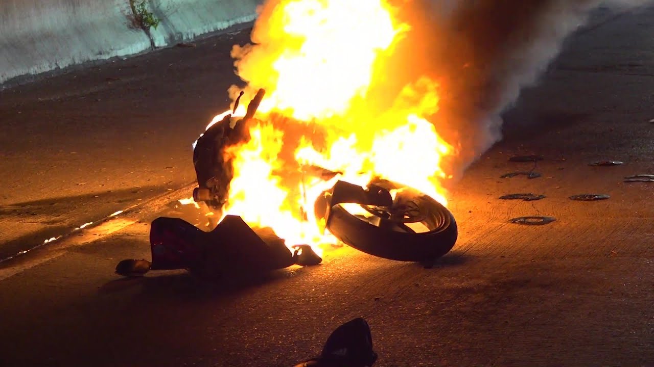Motorcycle catches fire after crash - YouTube