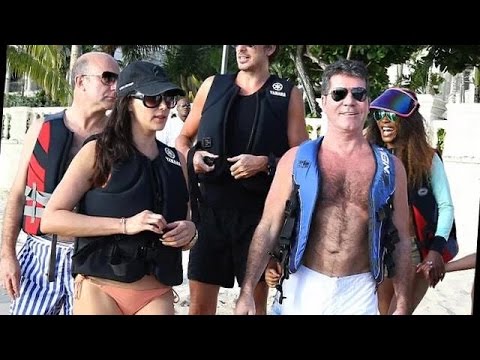 Simon Cowell and a bikini-clad Lauren Silverman jet ski in Barbados as they are joined by..