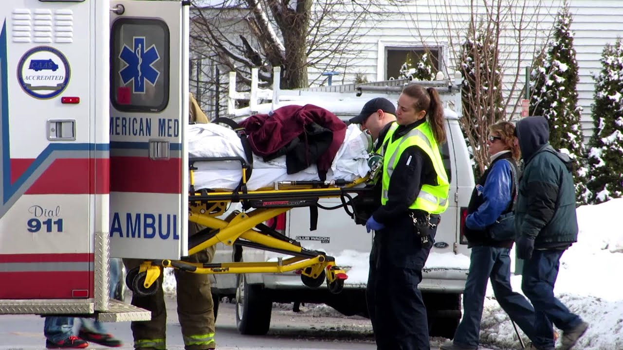 Manchester, NH - Responders put a body on a stretcher into an ambulance ...
