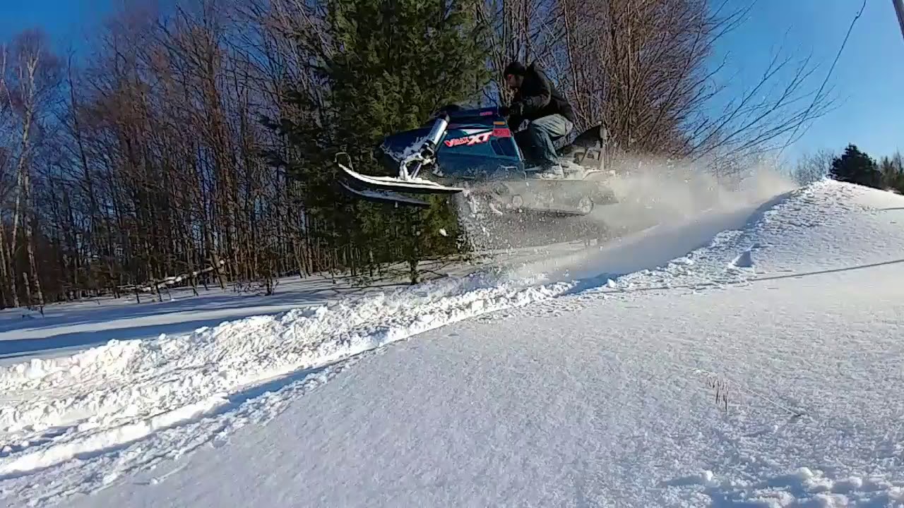 Snowmobile takes massive jump - YouTube