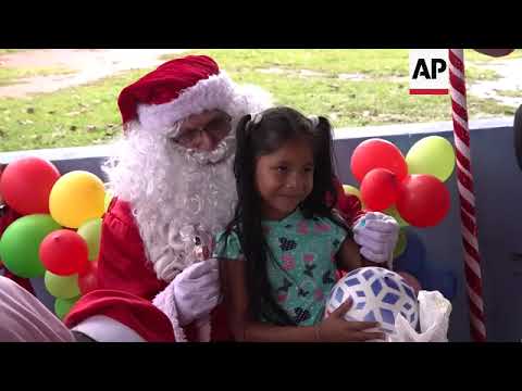 Santa goes into the jungle in a motorized fishing boat
