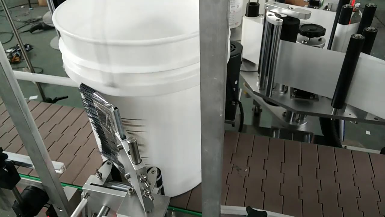automatic pail labeling machine - YouTube