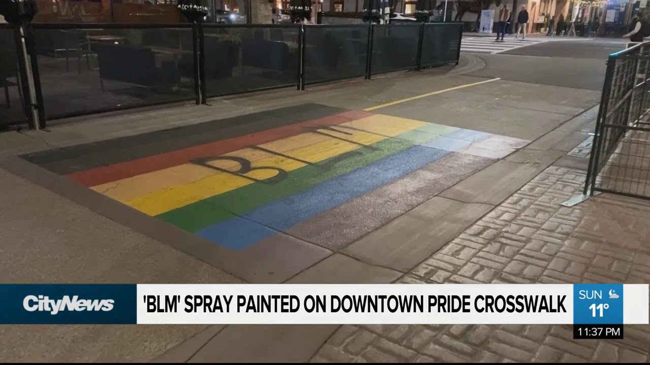 The letters BLM spray painted over the pride crosswalk - YouTube
