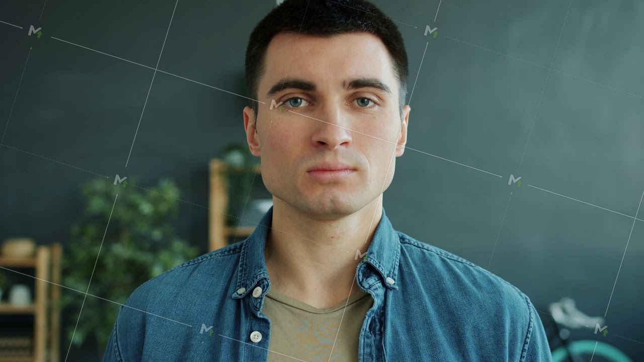 Slow motion portrait of serious young man looking at camera standing ...