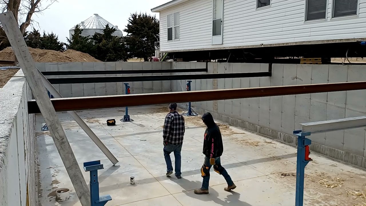 Double wide rolled over in one piece on a 9ft basement - YouTube