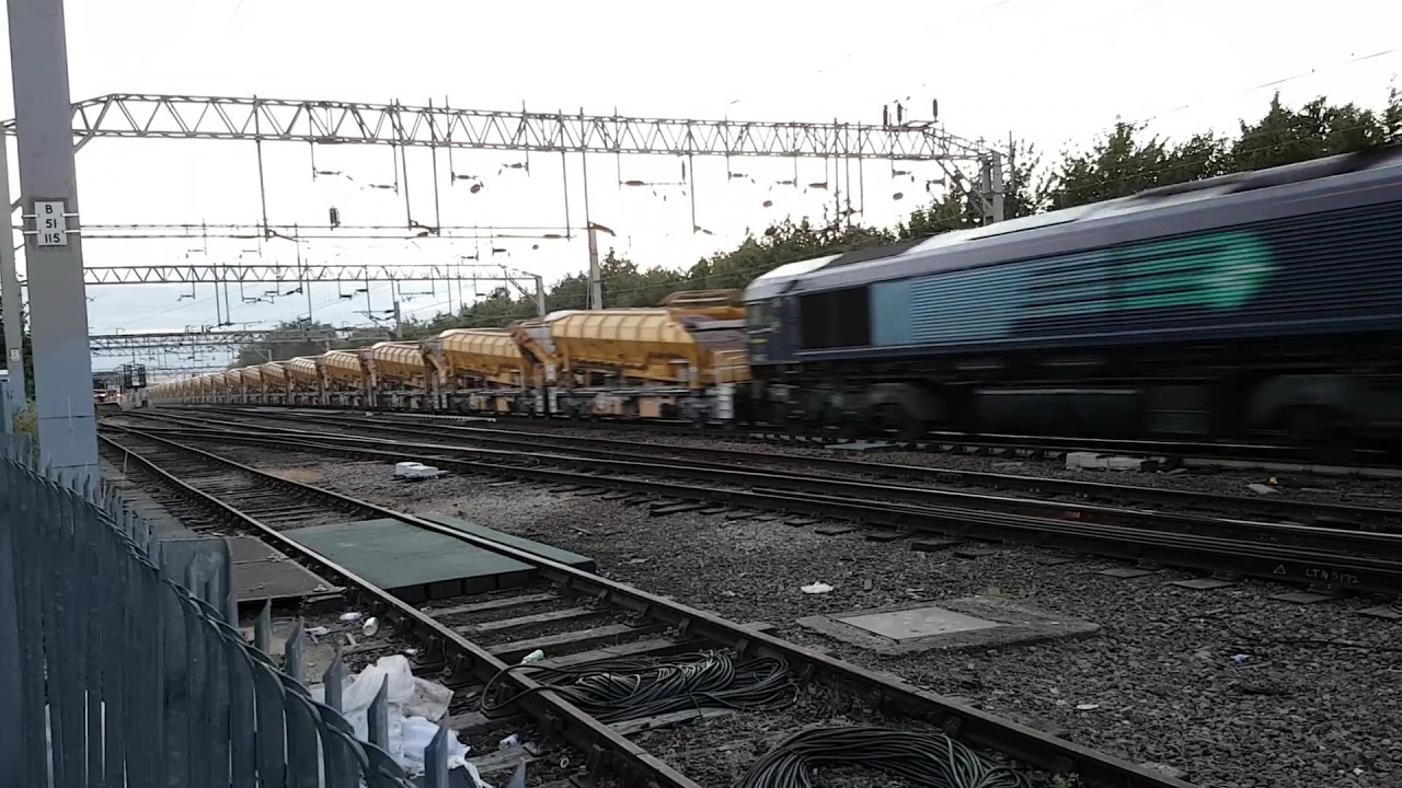 The very lengthy Network Rail HOBC (High Output Ballast Cleaner) powers ...