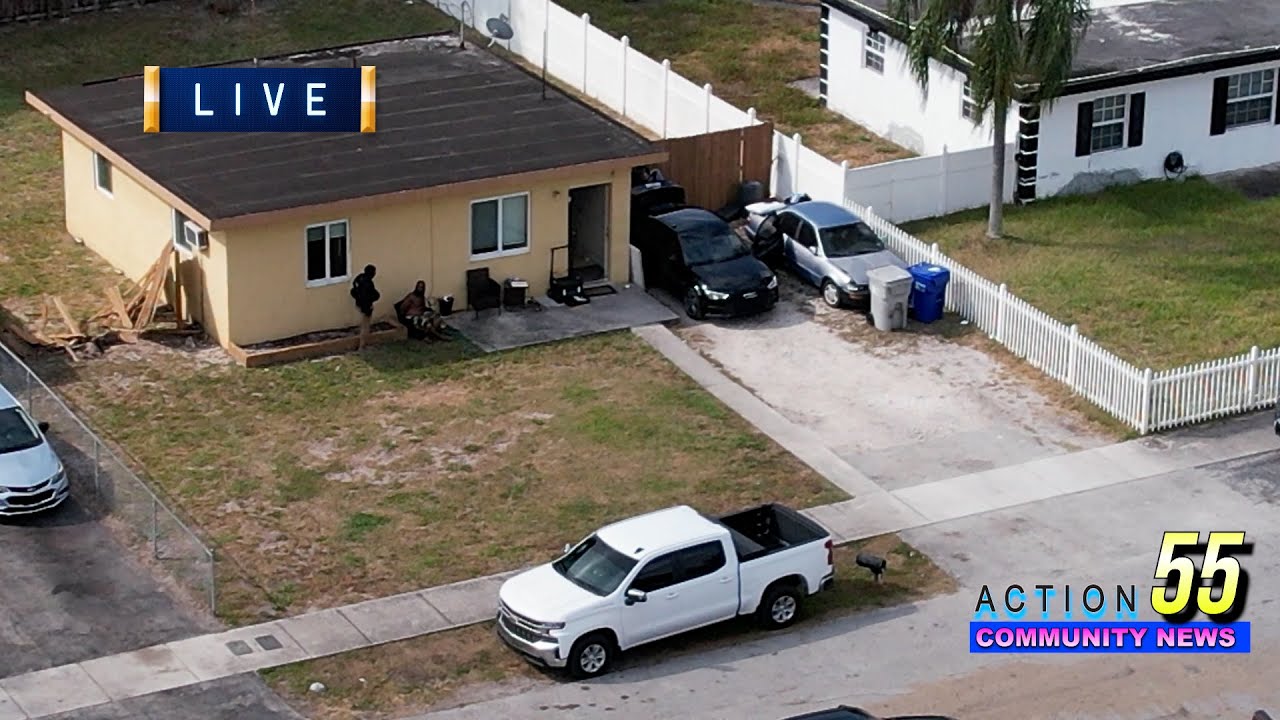 Swat Officers bust a door, two people later questioned as law ...