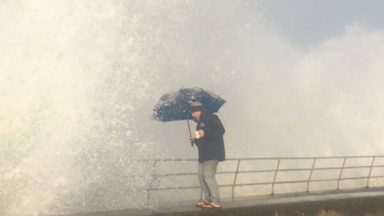 Wave Soaks Woman After Umbrella Fail - YouTube