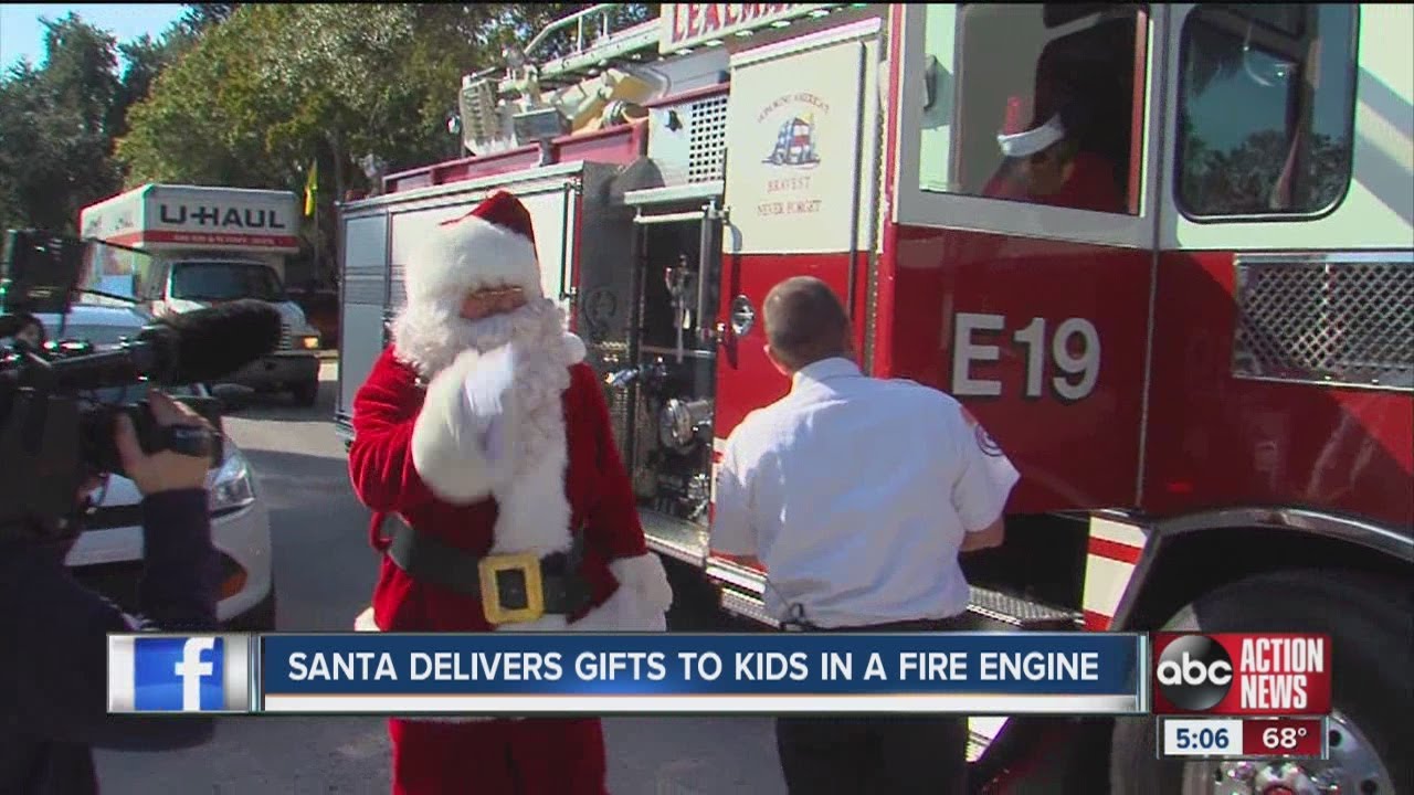 Santa deliveries presents to children in a fire engine - YouTube