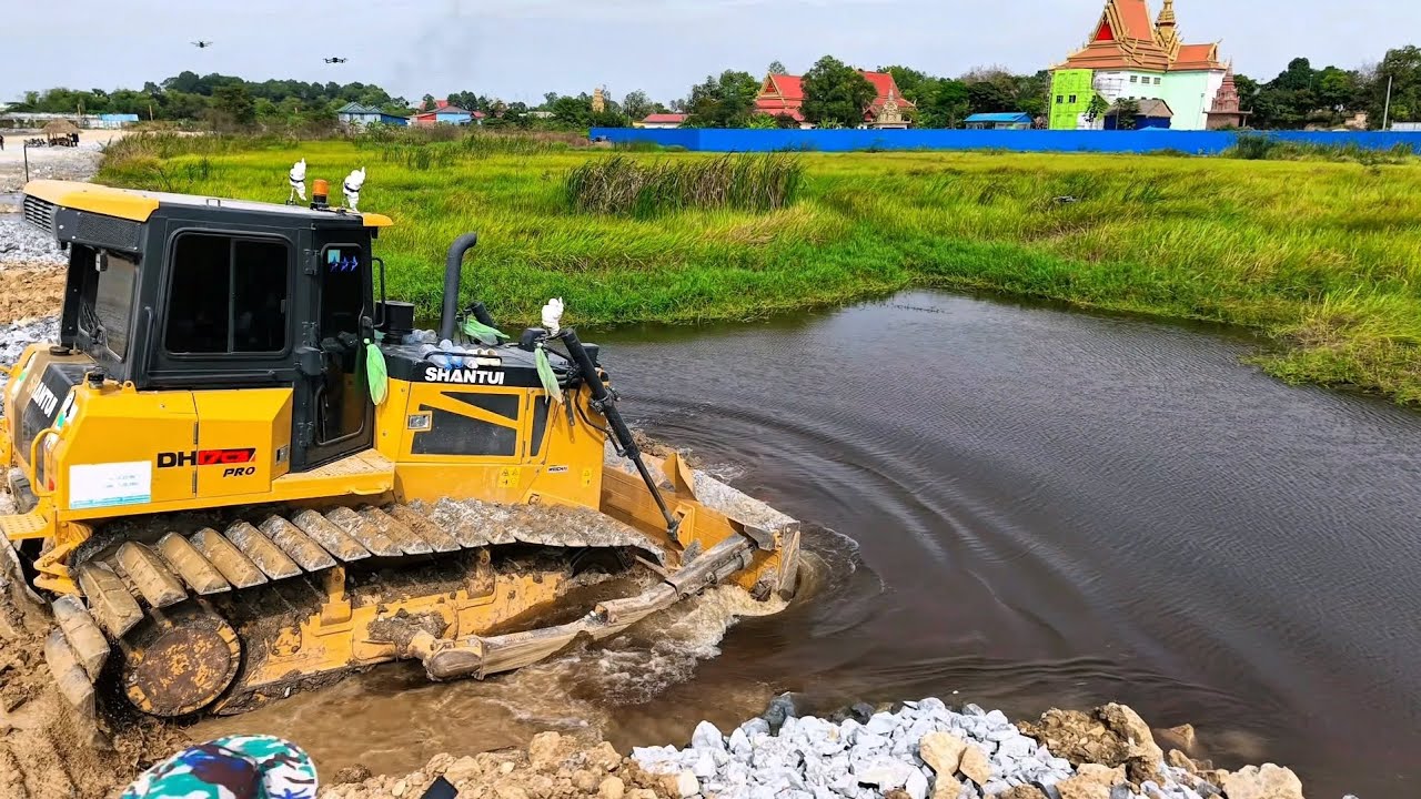 Smothly Dozer Building Road Construction Over The Water Using Stones ...