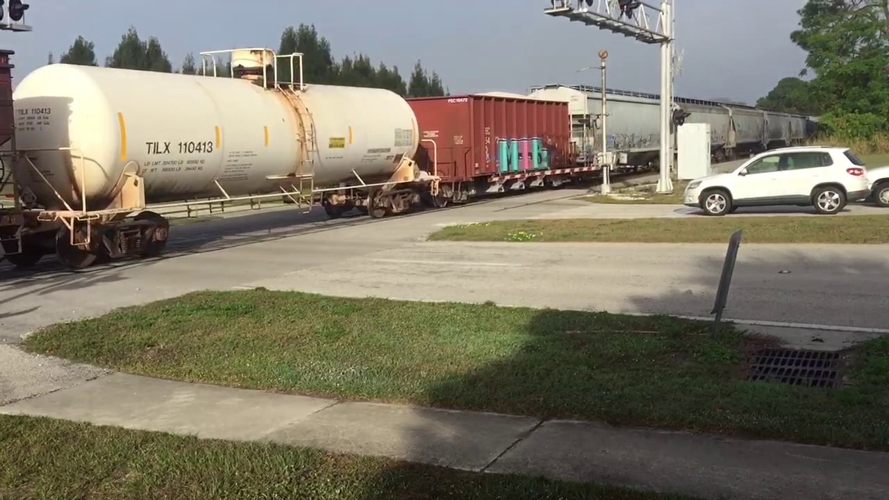 FEC TRAIN 141#2888@9:00am w/the most Tropicana juice cars I have seen ...