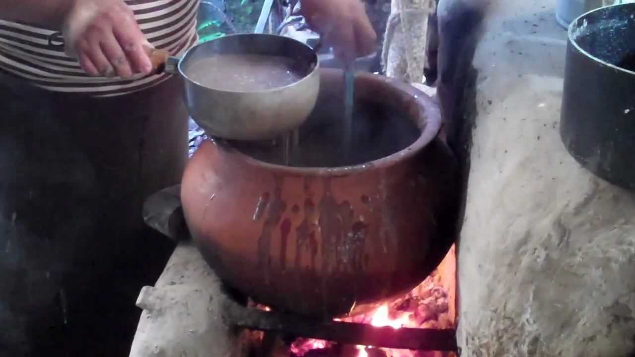 Haciendo Champurrado o Atole en fuego de lena; Making Atole over a wood ...