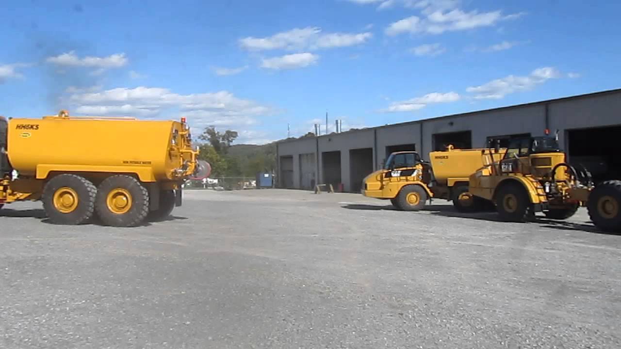 Caterpillar 745C chassis, (2) CAT 730 and John Deere 300D water trucks ...