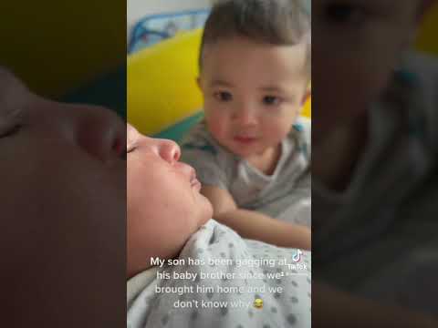 Boy gags looking at baby brother