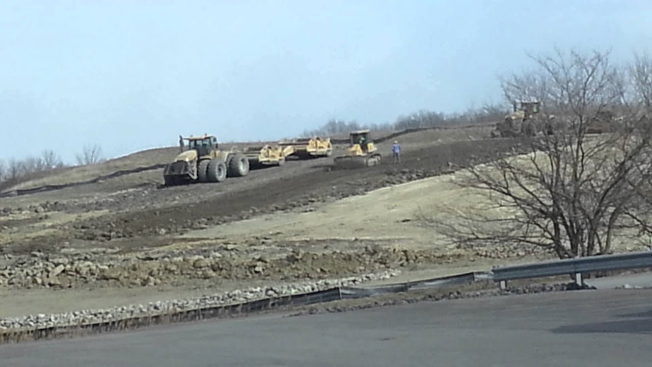 Challenger Cat tractor pulling 3 scrapers uphill - YouTube